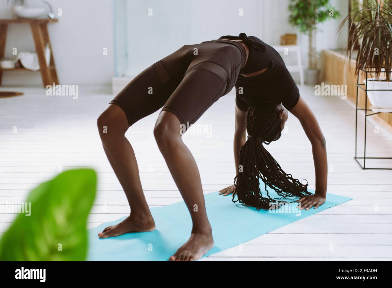 Athletic afro american woman with dreadlocks standing on gymnastic ...