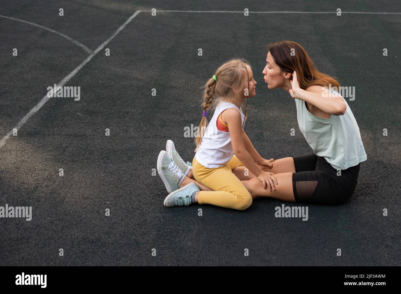 Mother and daughter go in for sports outdoors. Caucasian woman and ...