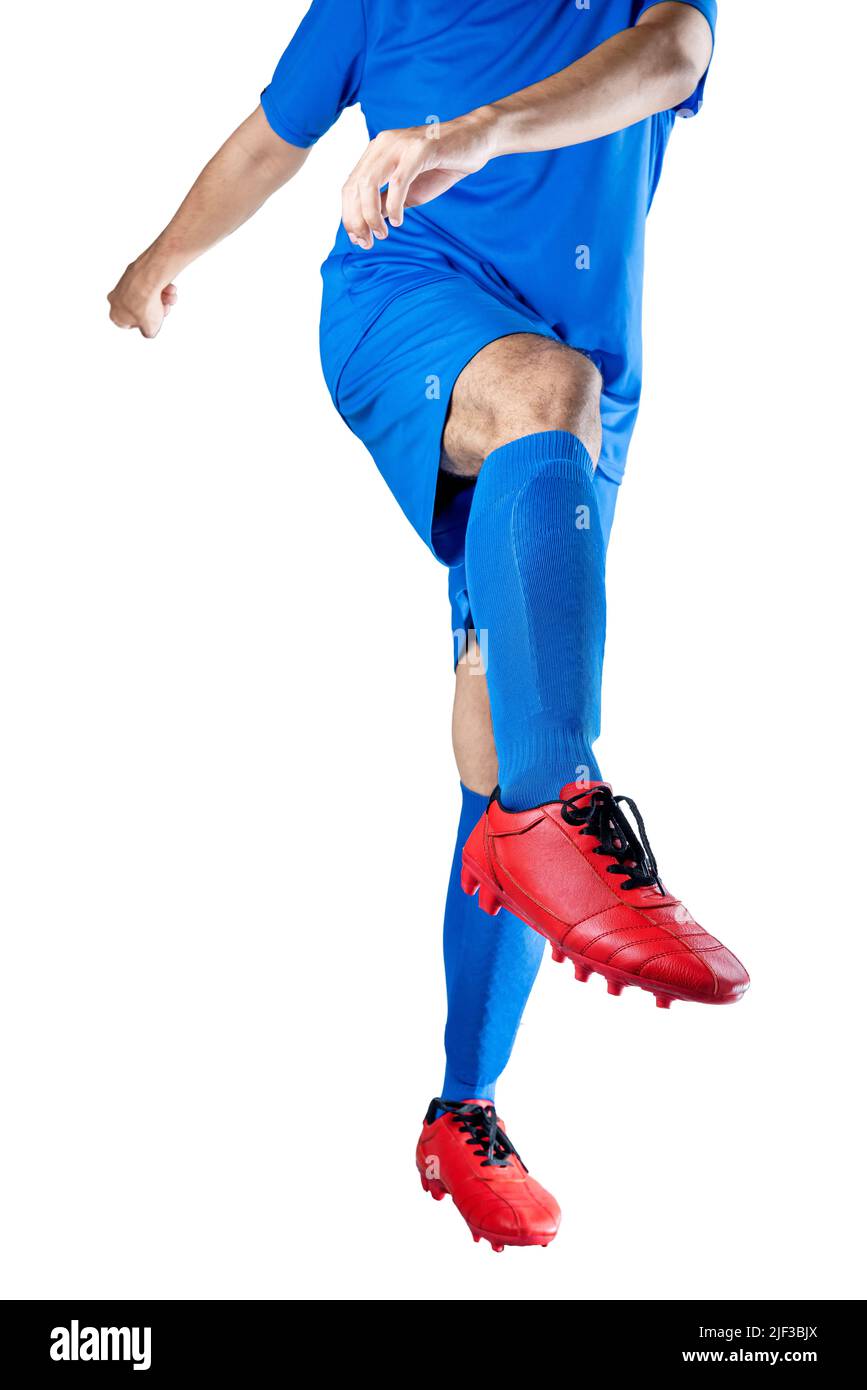 Football player man in a blue jersey with the pose of kicking the ball ...