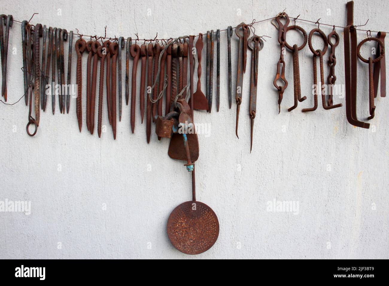 Old rusty blacksmith tools on the wall Stock Photo - Alamy