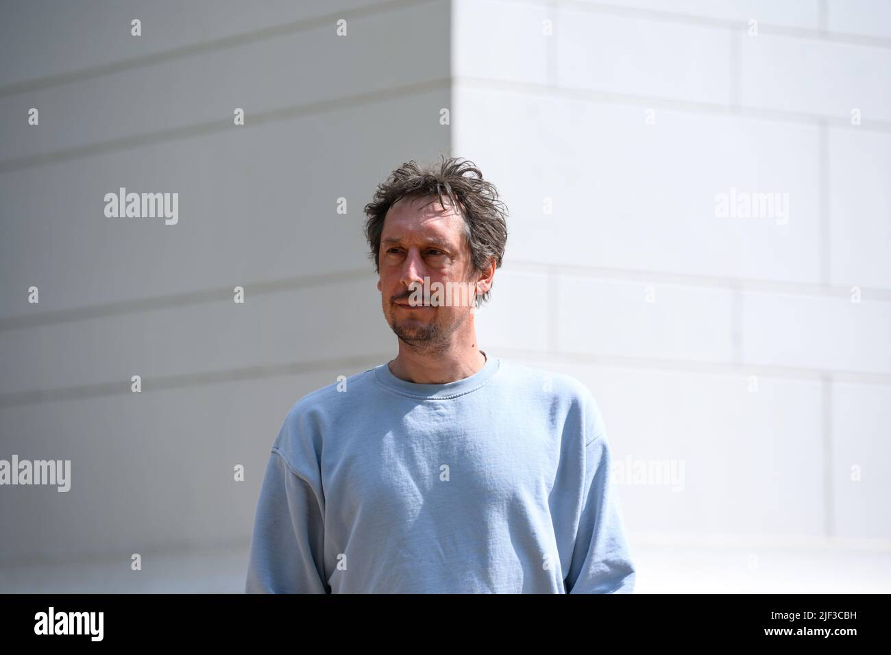 Hamburg, Germany. 11th June, 2022. Actor Hans Löw stands in front of ...