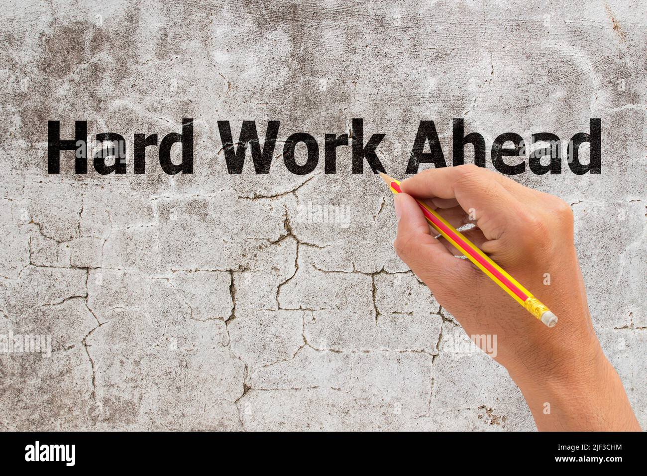 Hand with marker writing the text - Hard Work Ahead on grunge ...