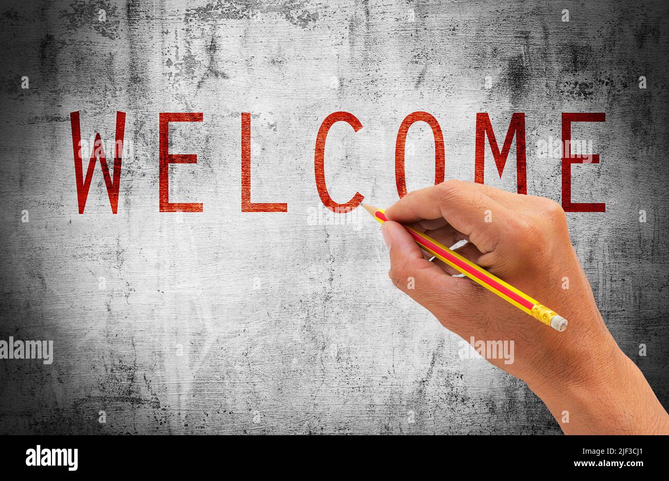 Hand writing text with WELCOME on grunge wall background Stock Photo ...