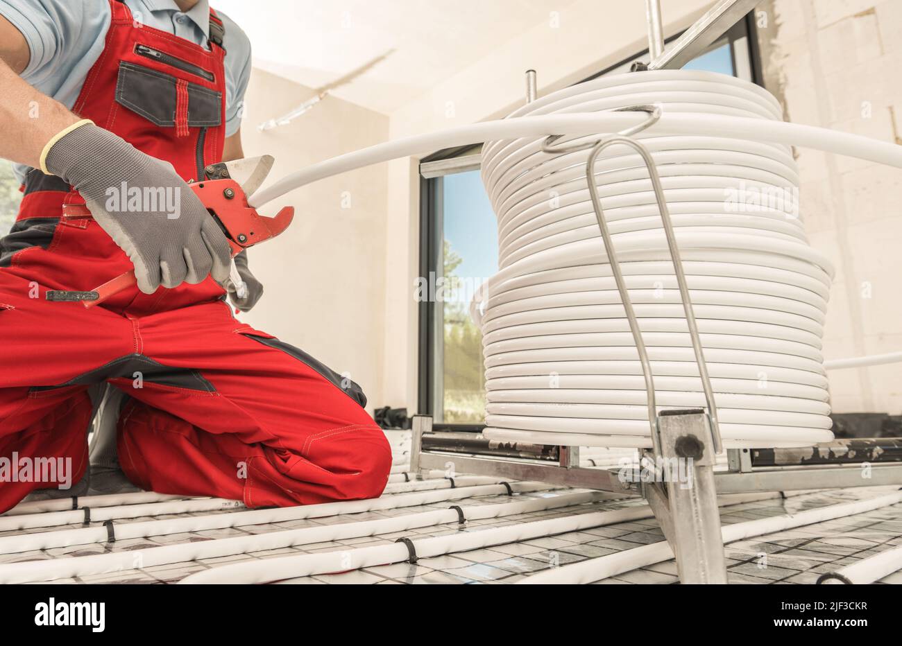 Caucasian HVAC Worker with Tube Slicer in His Hand Cutting Radiant ...