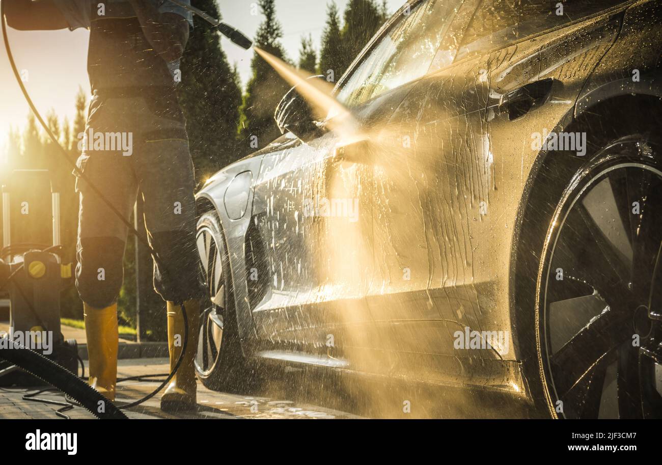 Men Washing His Modern Luxury Car Using Powerful Pressure Washer During ...