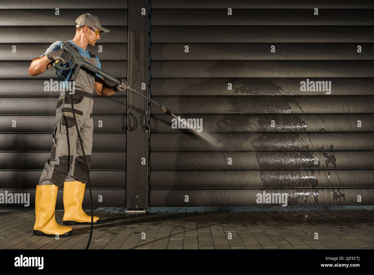 Caucasian Worker in His 40s Cleaning Modern Aluminium Pergola Power ...