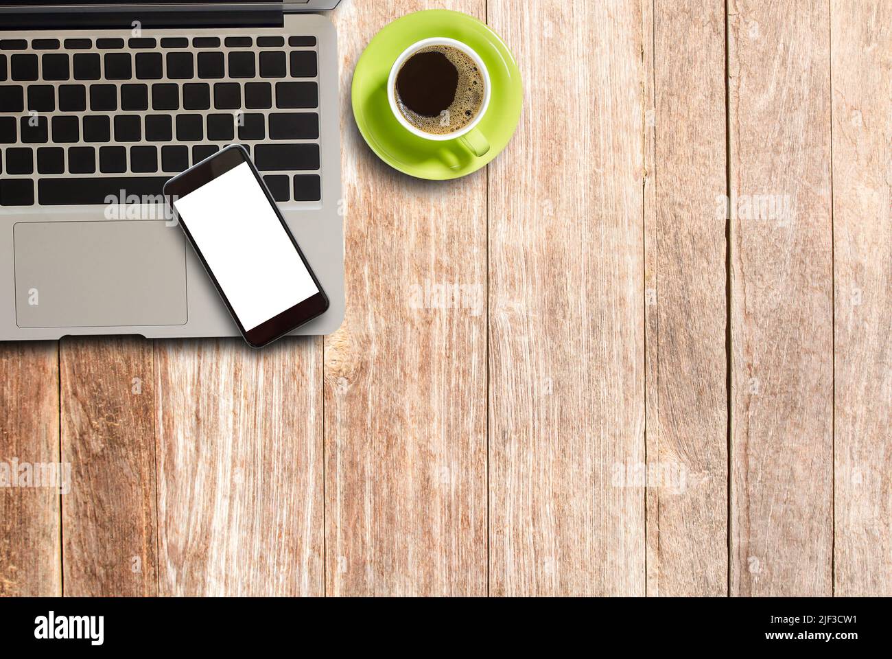 Modern wood office desk table with laptop,smart phone,cup of coffee and ...