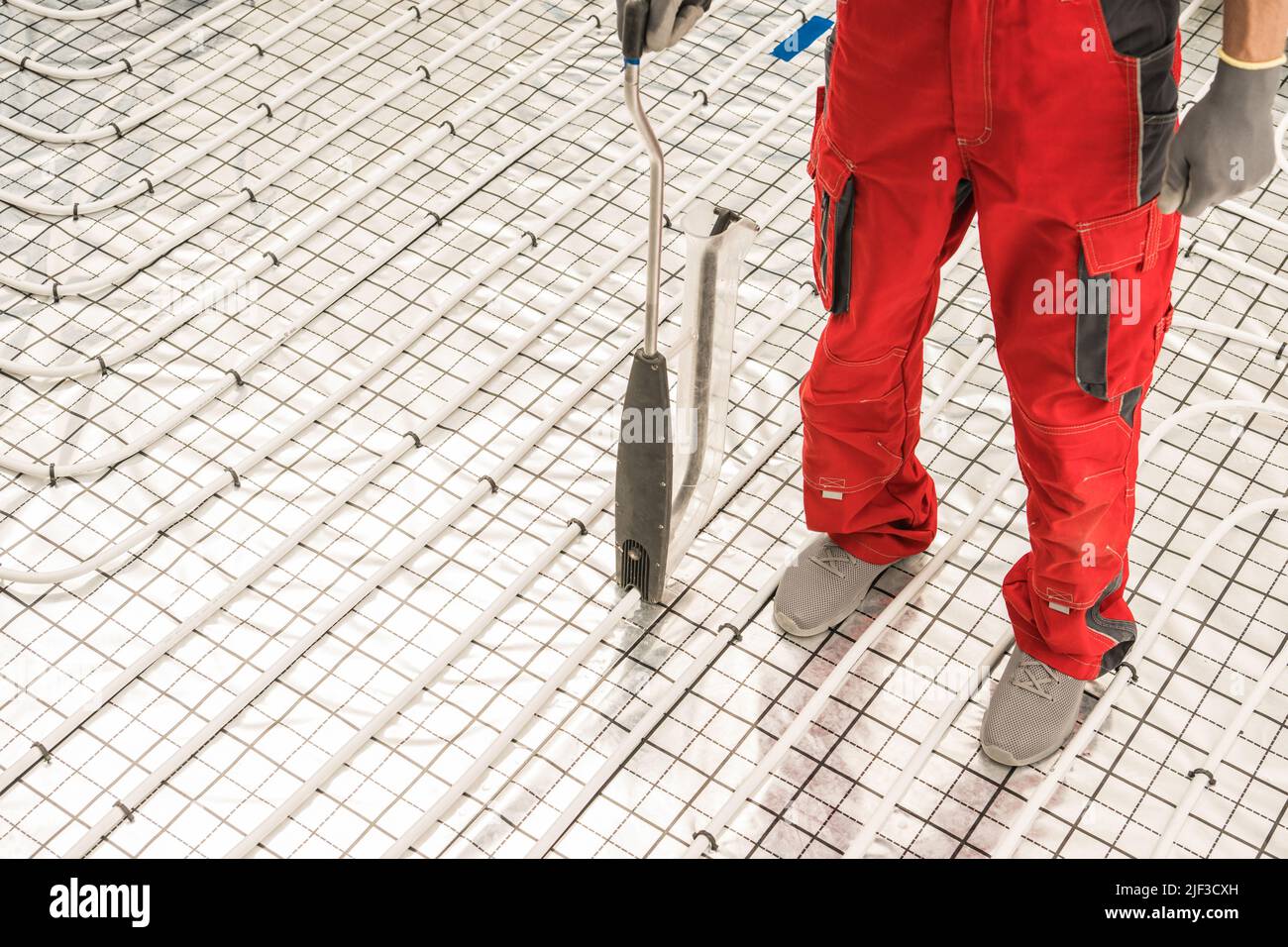 Caucasian HVAC Worker Using Floor Radiant Heating Pipeline Foam Board ...