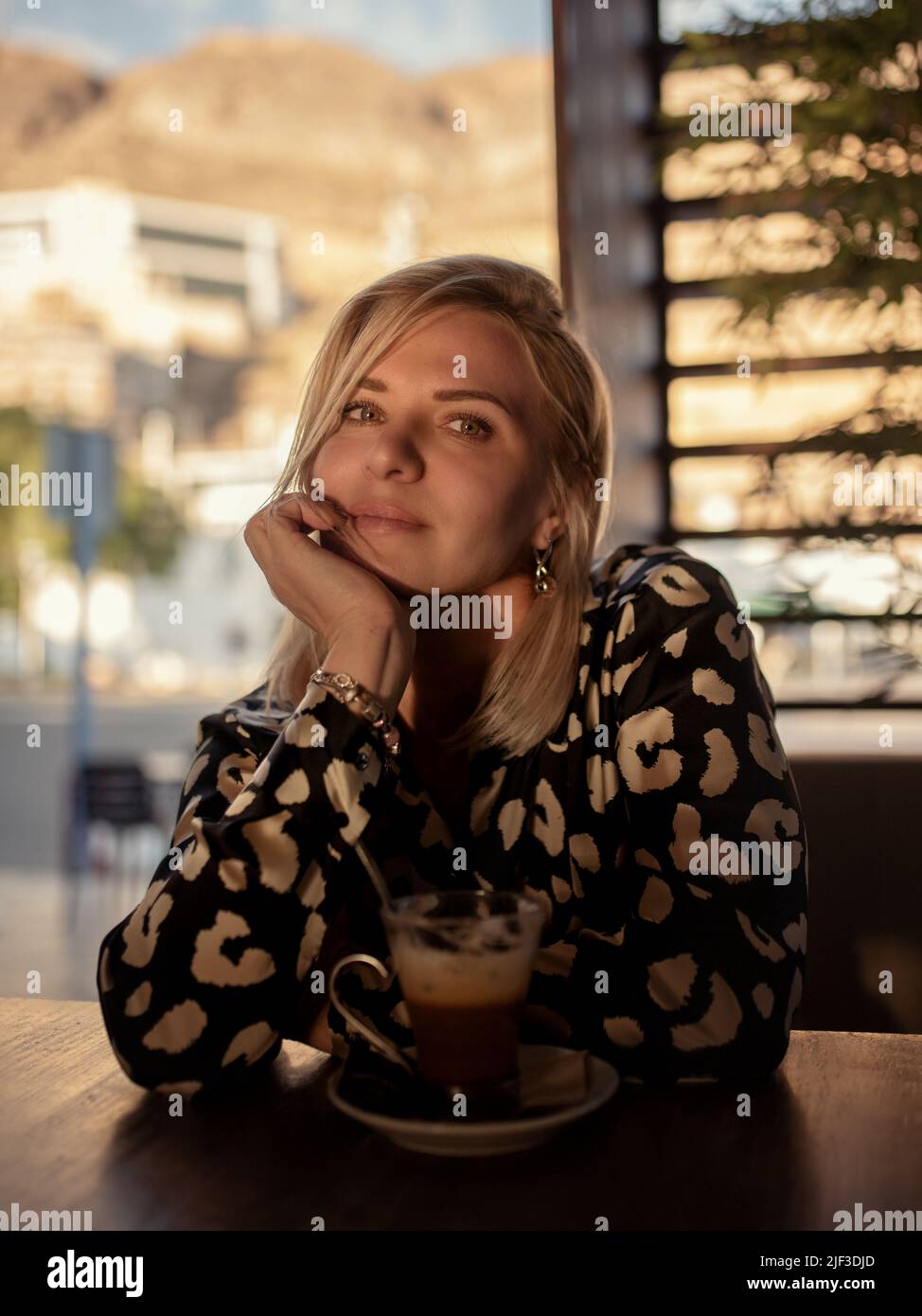 Attractive lady enjoys a cup of coffee in the cafeteria Stock Photo - Alamy