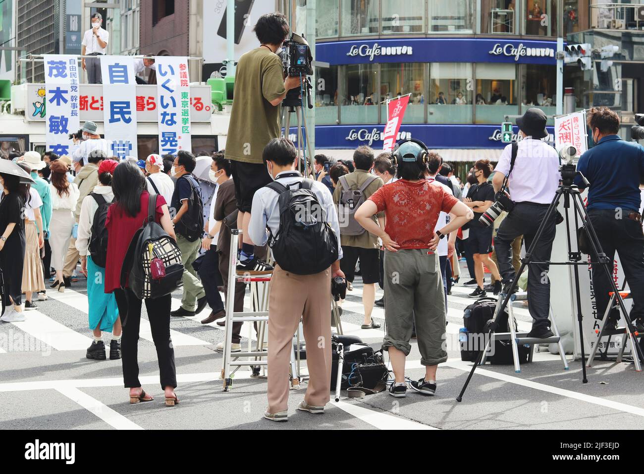TOKYO, JAPAN - June 26, 2022: TV crews, press, pedestrians and LDP ...