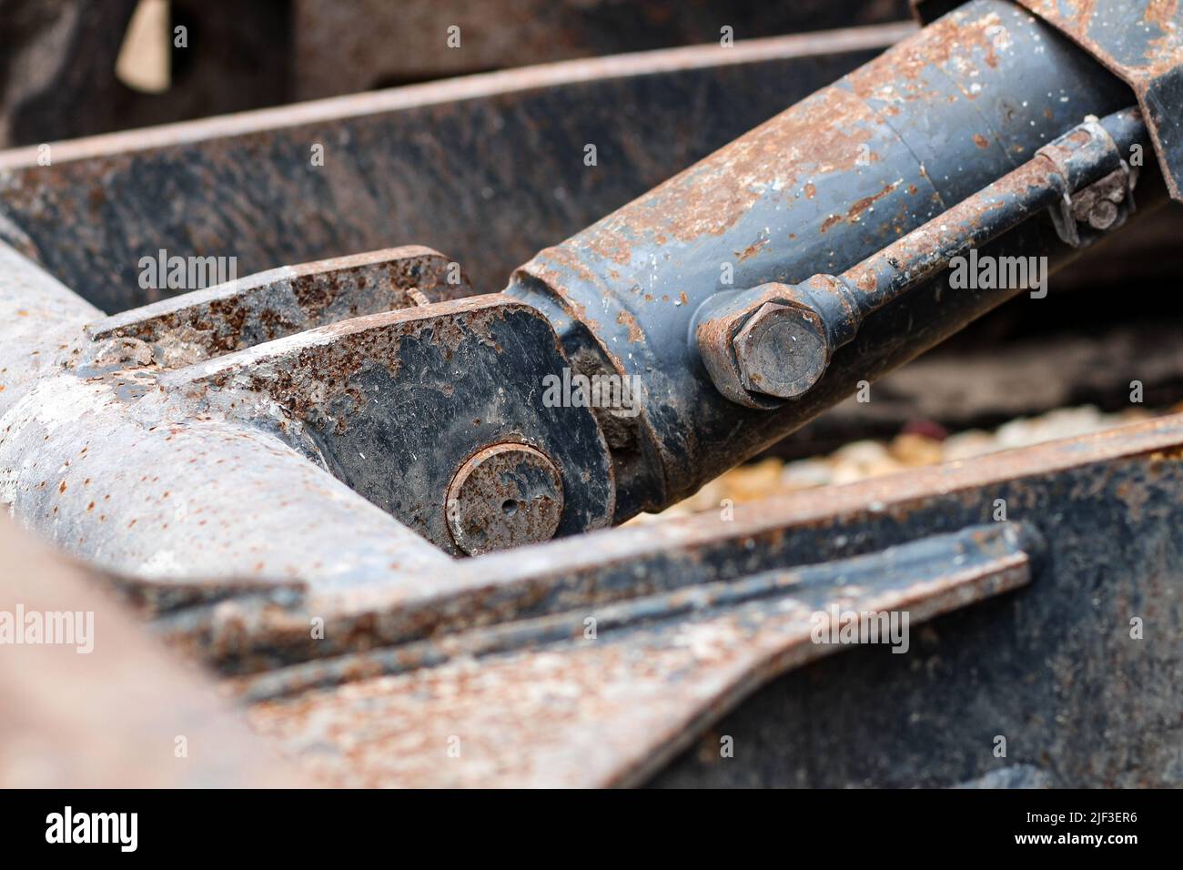 A close-up shot of a rusty old steel joint - construction machine part ...