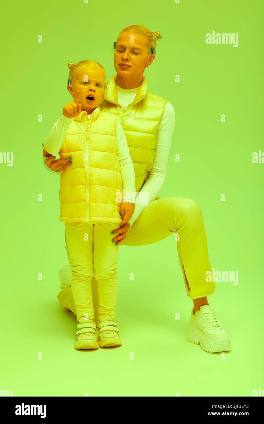 young woman with little girl wearing head mount display and futuristic ...