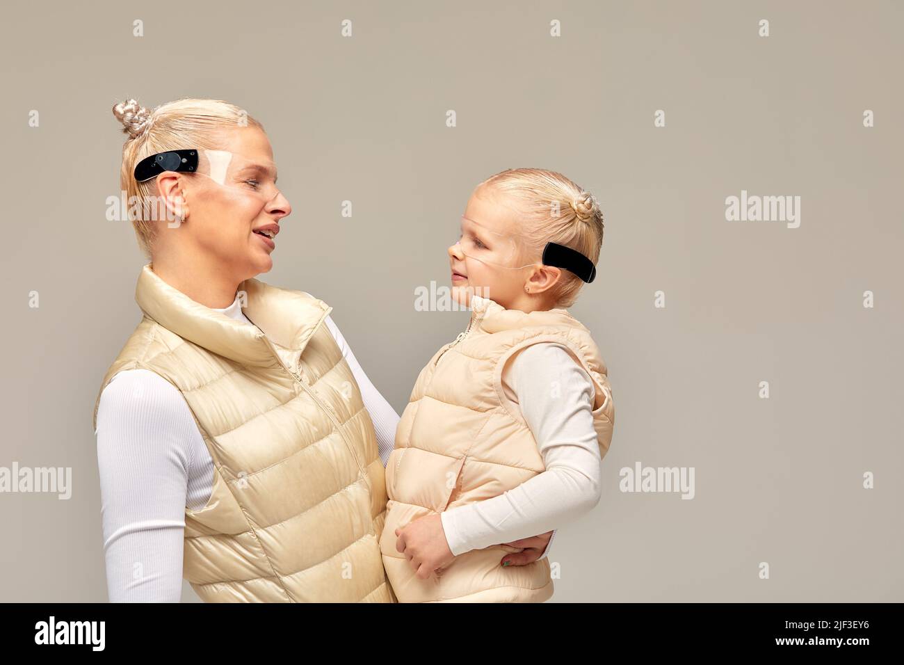 Virtual technology. Happy delighted nice girl smiling and looking at ...