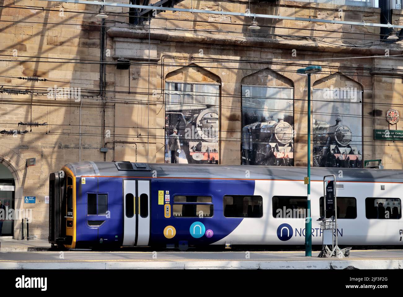 A modern diesel multiple unit at Carlisle Citadel station beneath ...