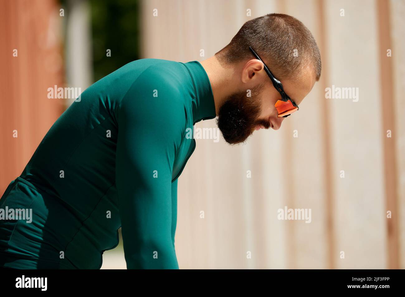 Portrait of a runner man take a rest after jogging while standing ...