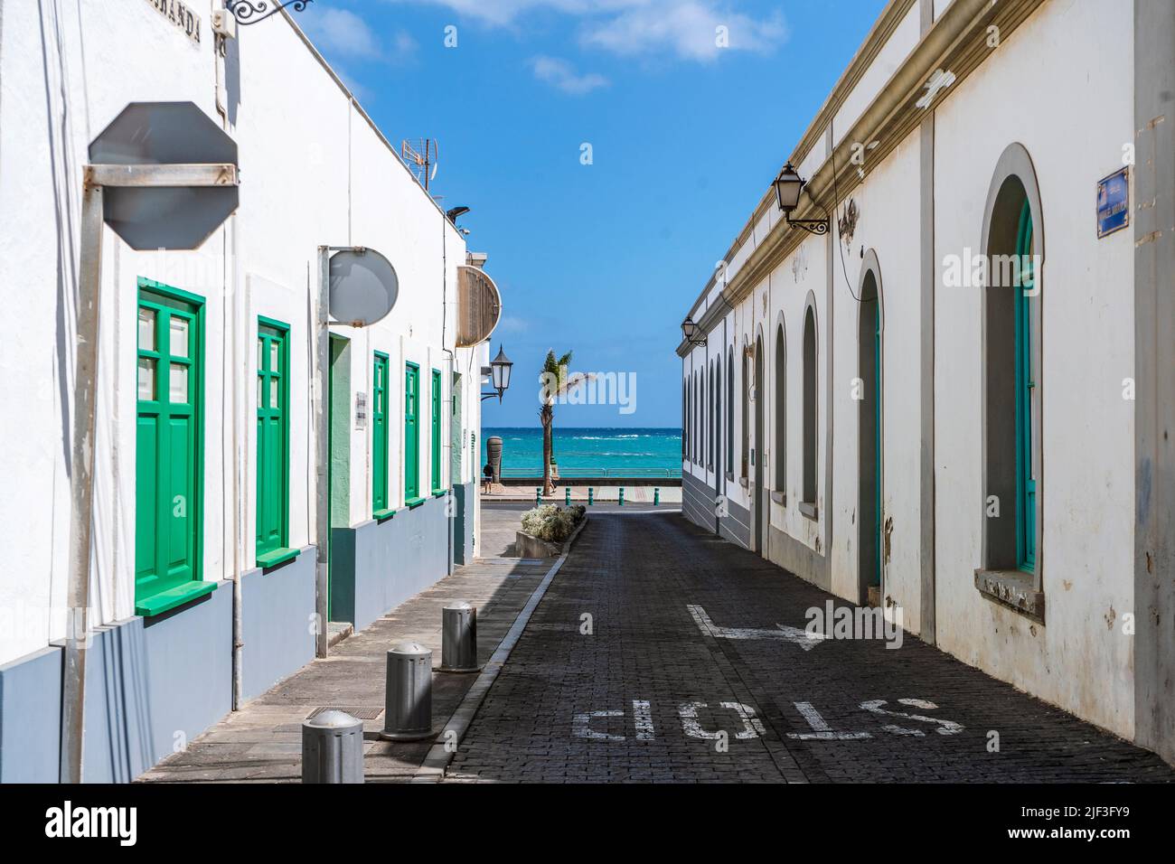 Charming traditional street with whitewashed houses and colorful ...