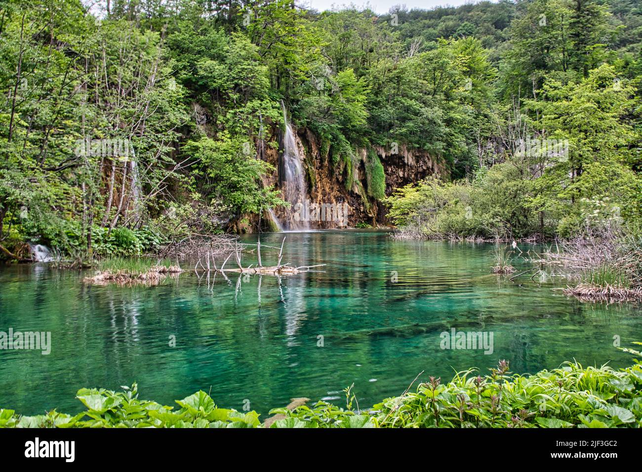 A breathtaking view of a waterfall in Plitvice Lakes National Park in ...
