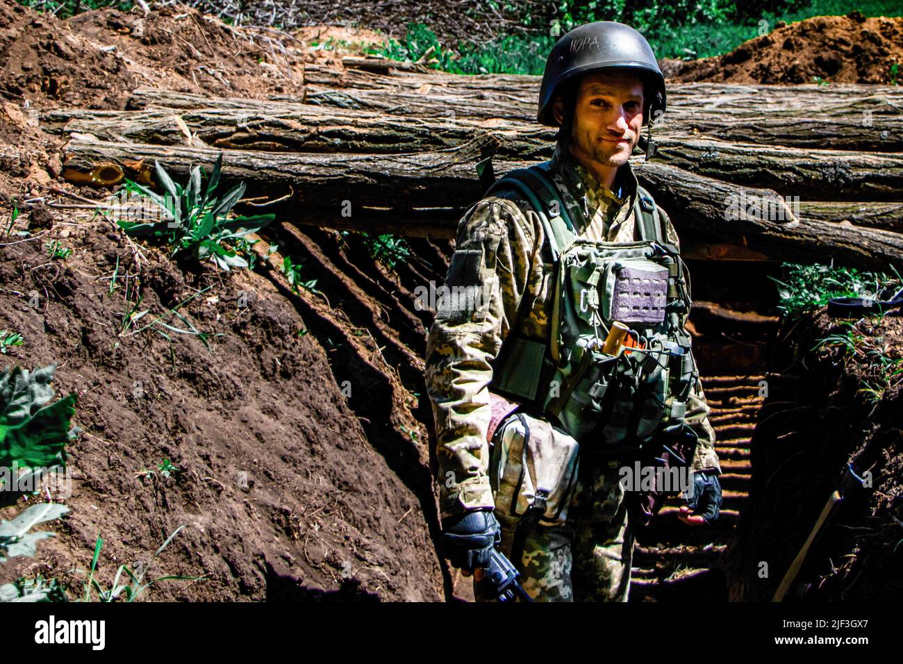 Military soldier is coming out of the ditch. Ukrainian military ...