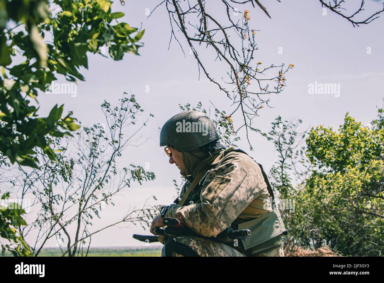 Military soldier at his positions by the frontline. Ukrainian military ...