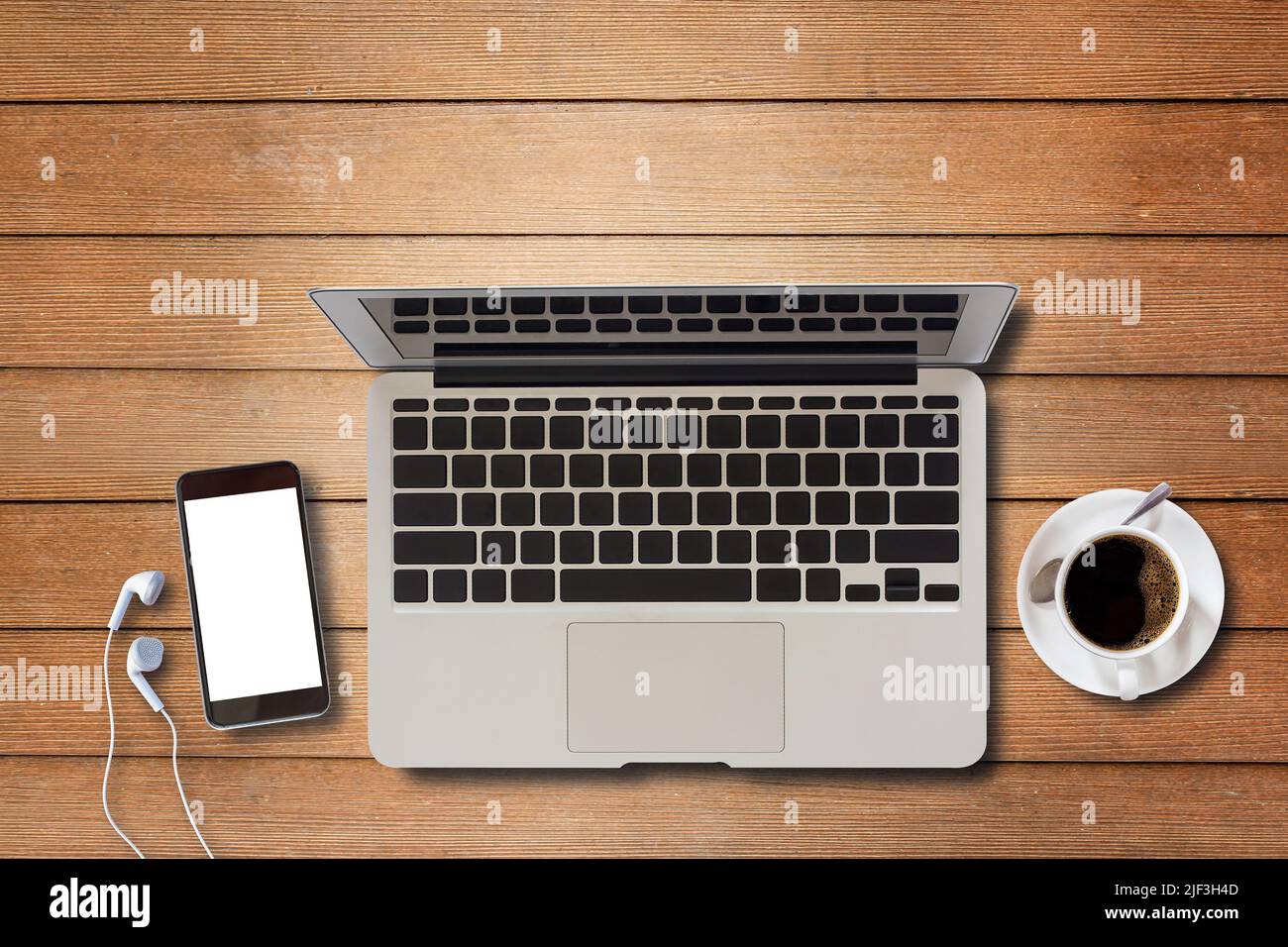 Laptop computer and smart phone with coffee cup on wood table top view ...