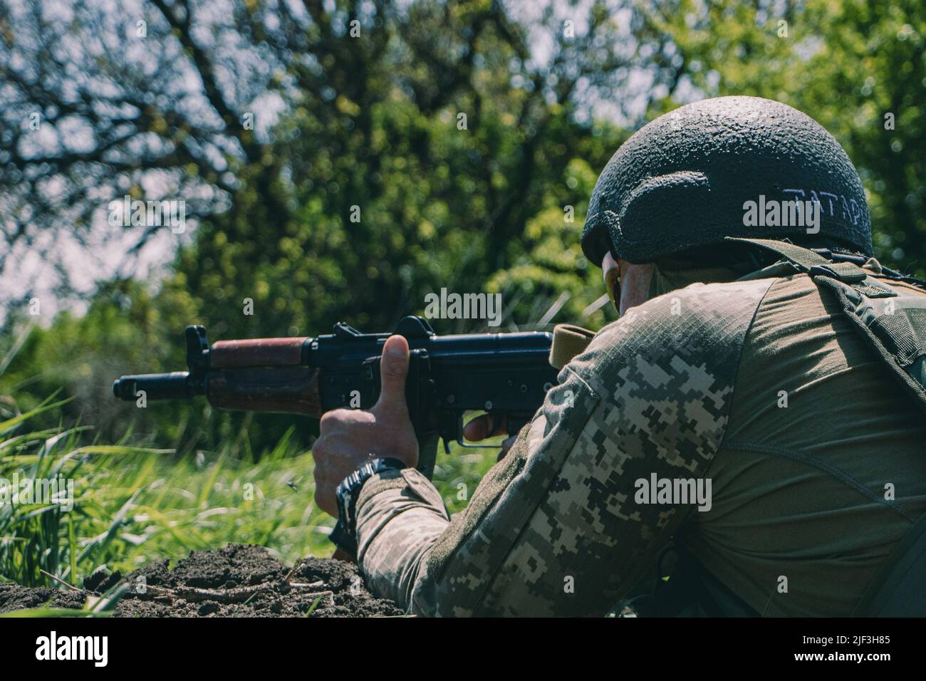 Military soldier at his position by the frontline. Ukrainian military ...