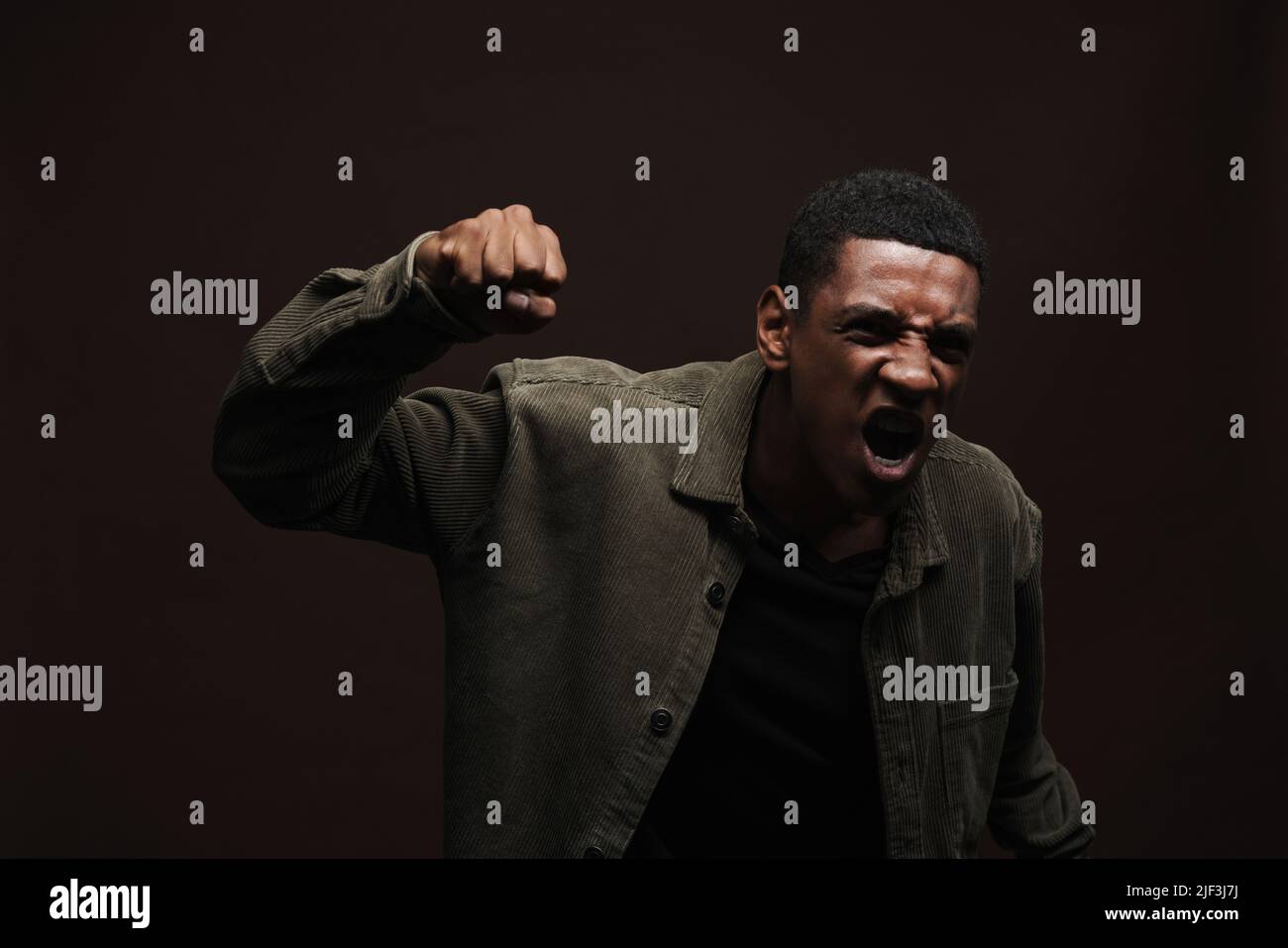 Young black man screaming while making winner gesture isolated over ...
