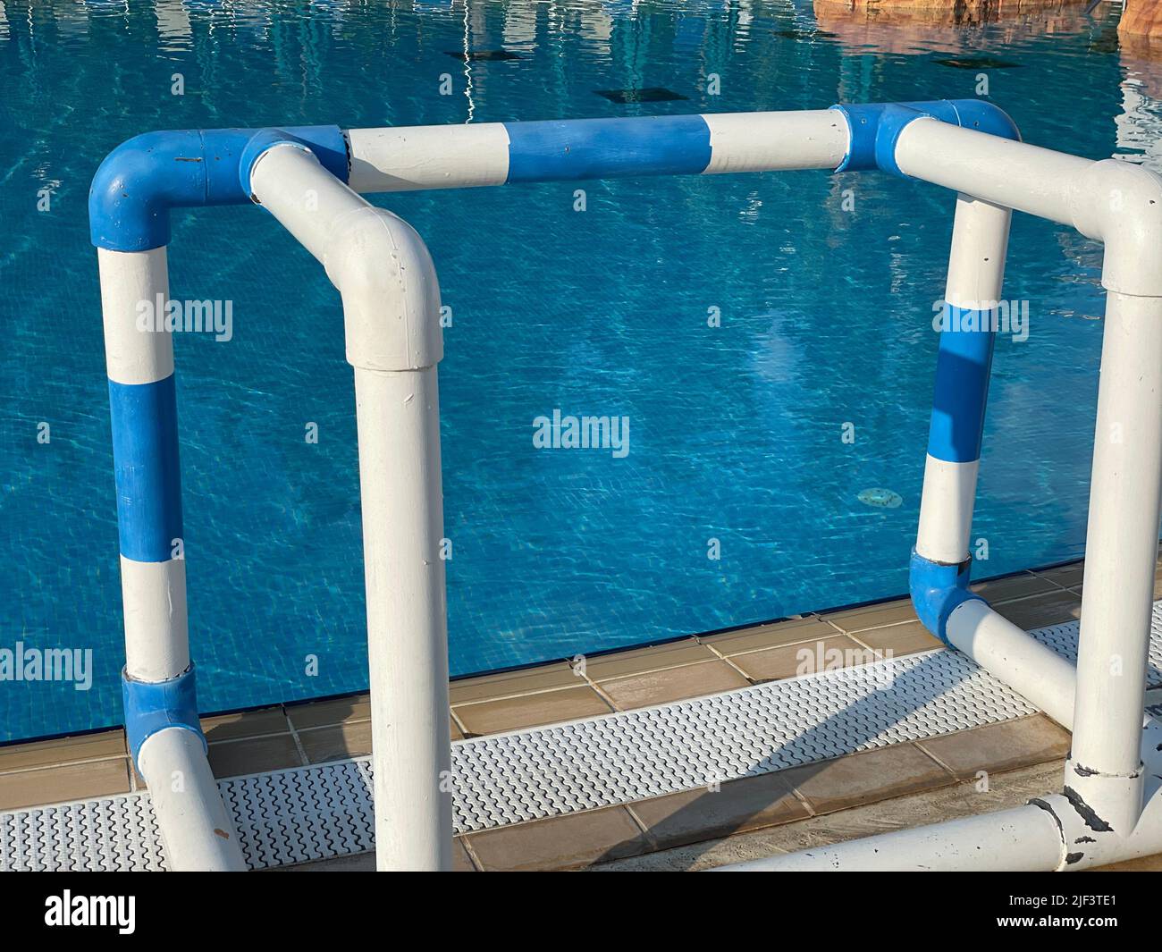 Swimming pool with gate at hotel close up Stock Photo - Alamy