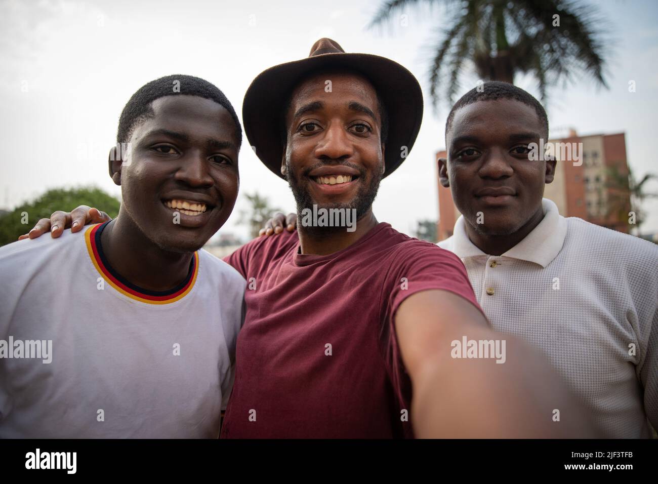 Three young friends take a selfie and are smiling and happy, African ...