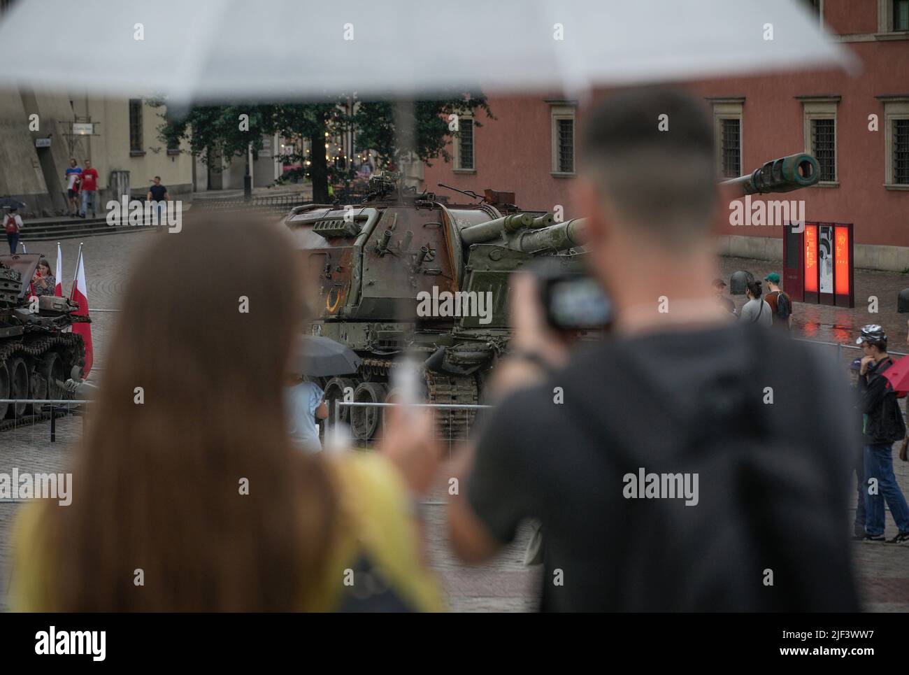 Visitors look at Russian tanks on display near the Royal Castle in ...