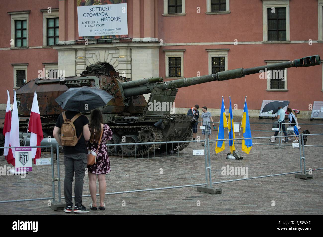 Visitors look at Russian tanks on display near the Royal Castle in ...