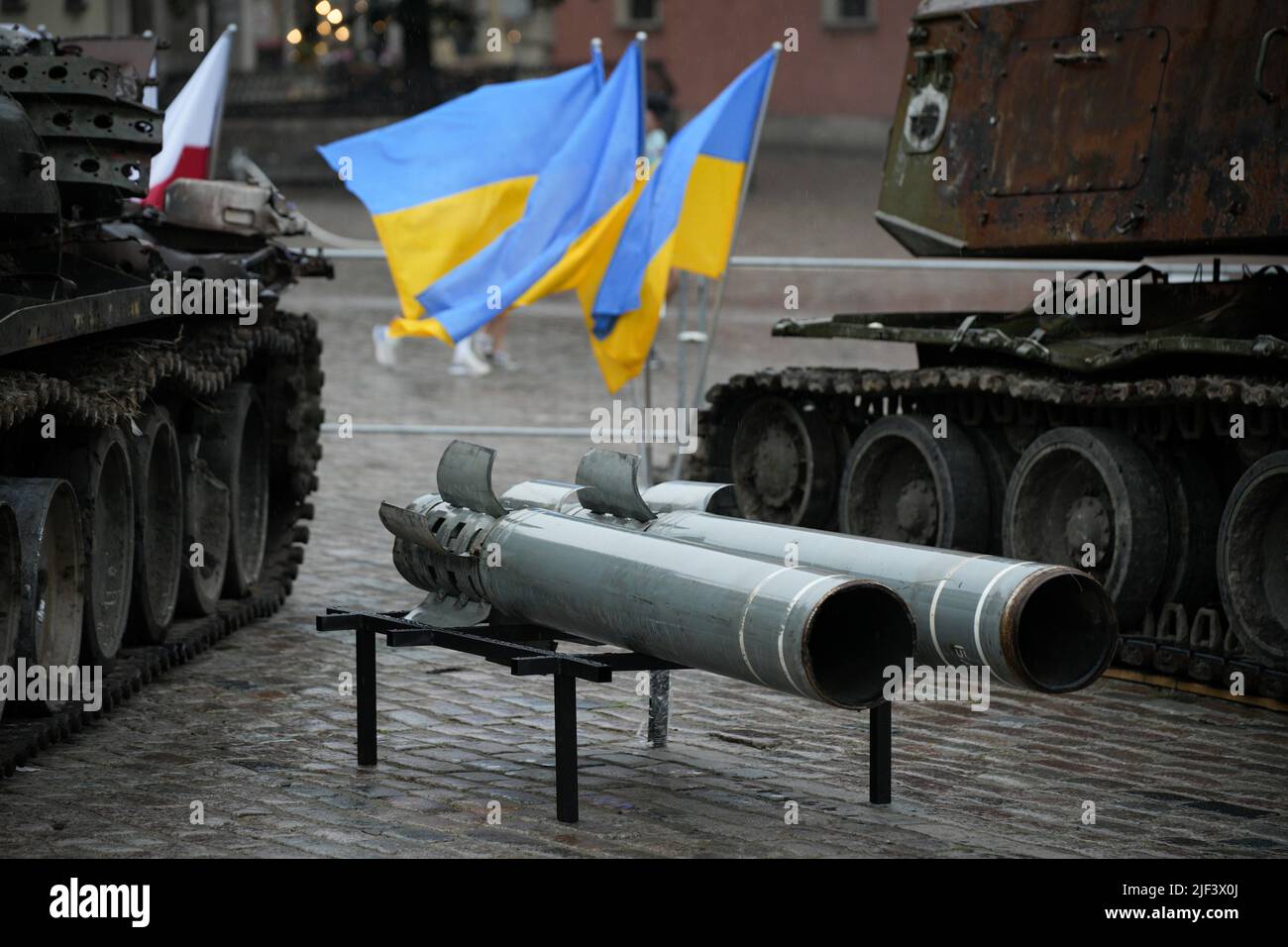 Visitors look at Russian tanks on display near the Royal Castle in ...