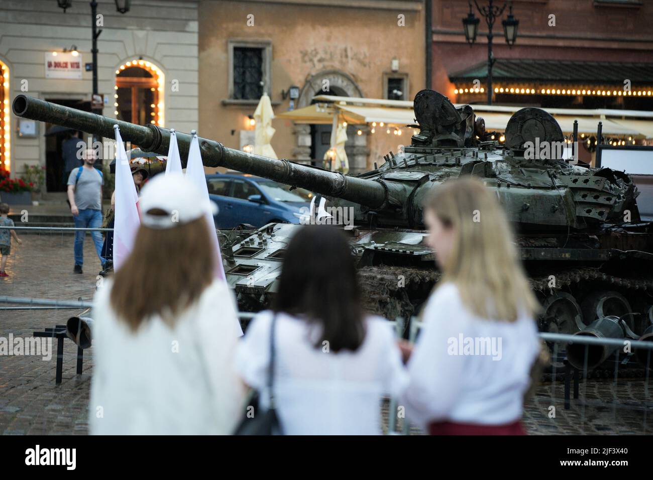 Visitors look at Russian tanks on display near the Royal Castle in ...