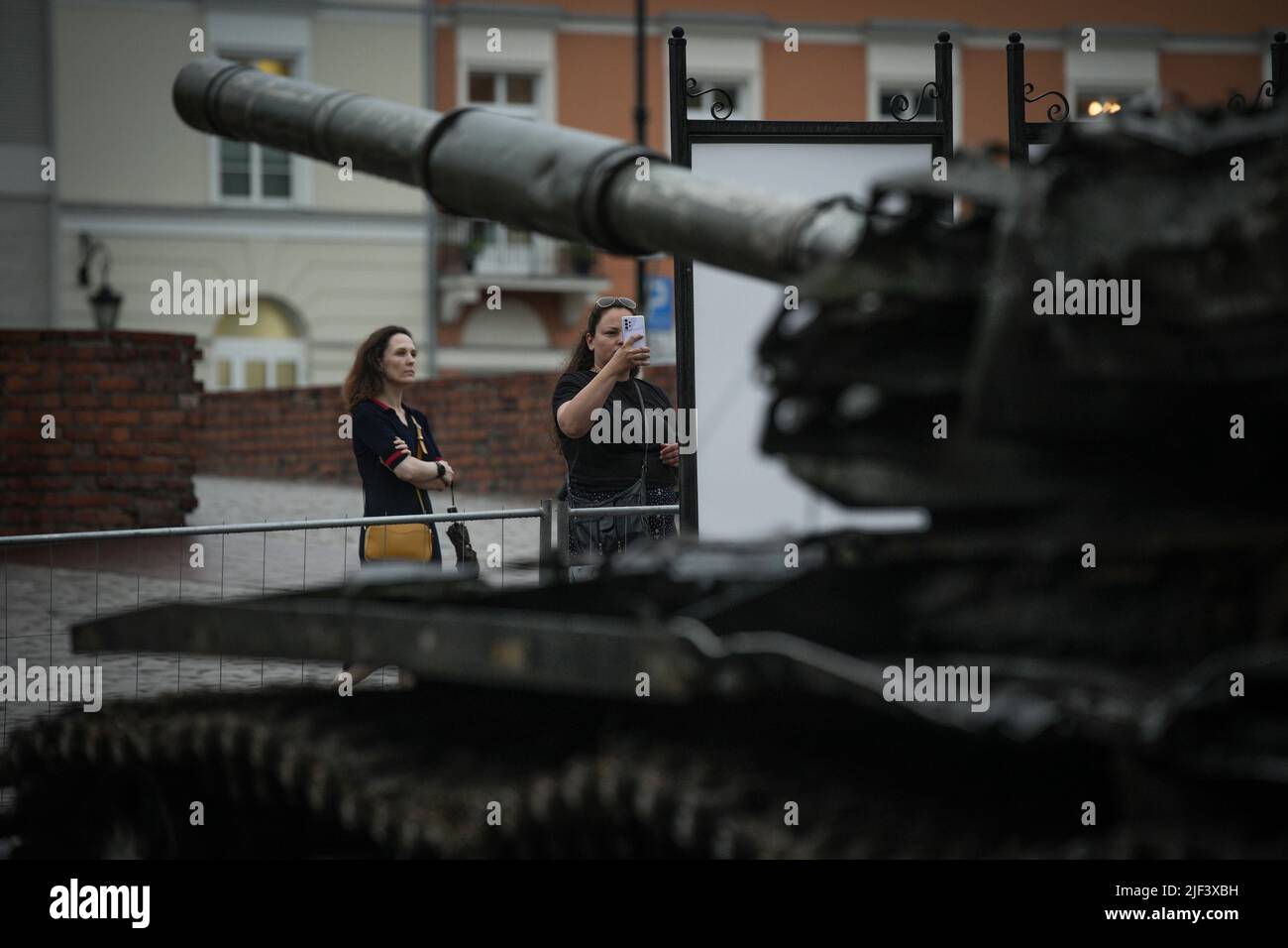 Visitors look at Russian tanks on display near the Royal Castle in ...