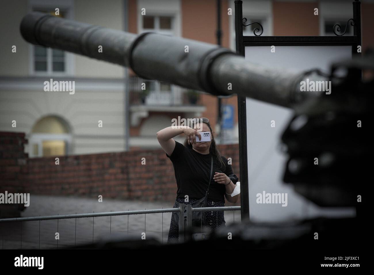 Visitors look at Russian tanks on display near the Royal Castle in ...