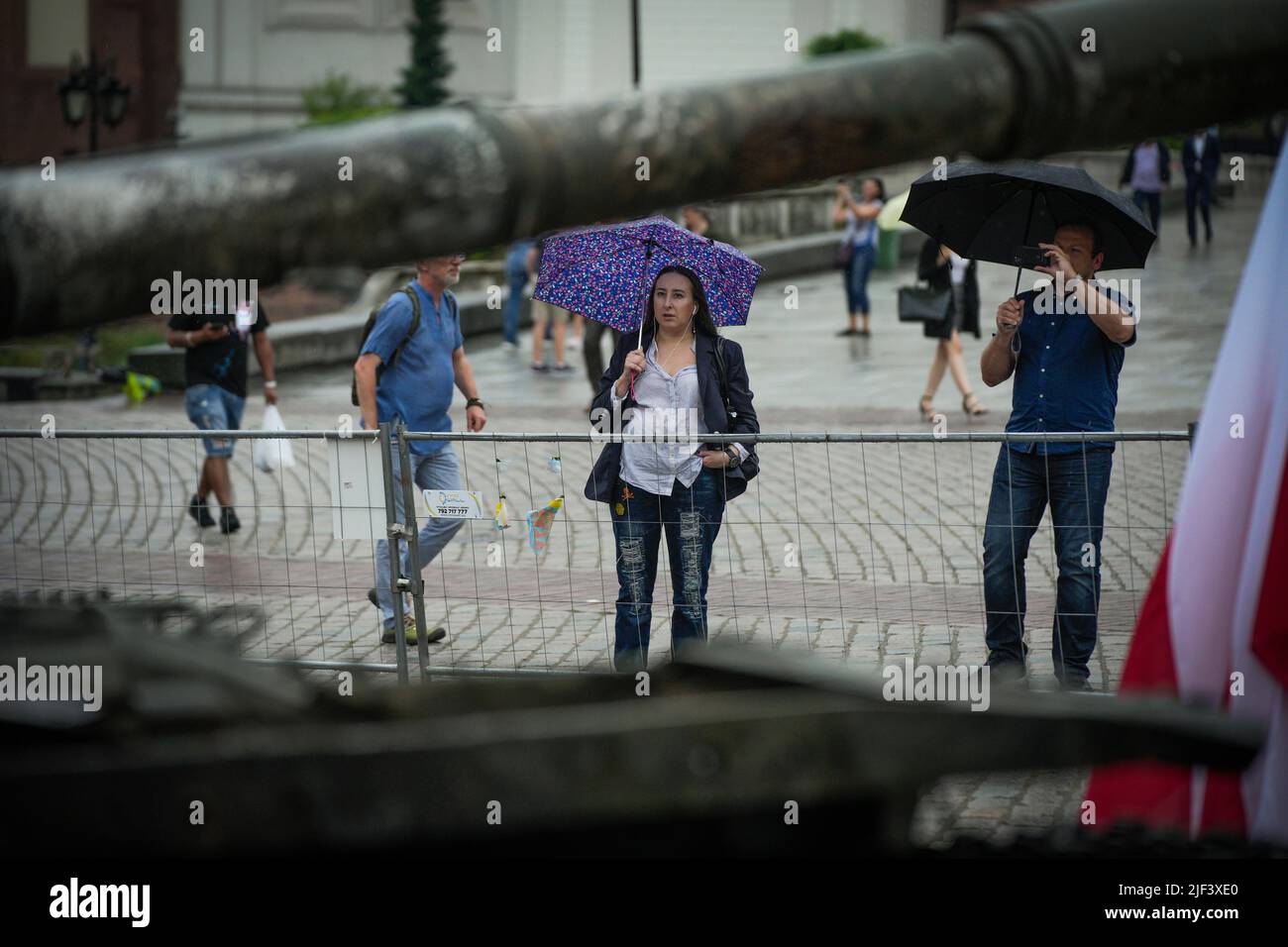 Visitors look at Russian tanks on display near the Royal Castle in ...