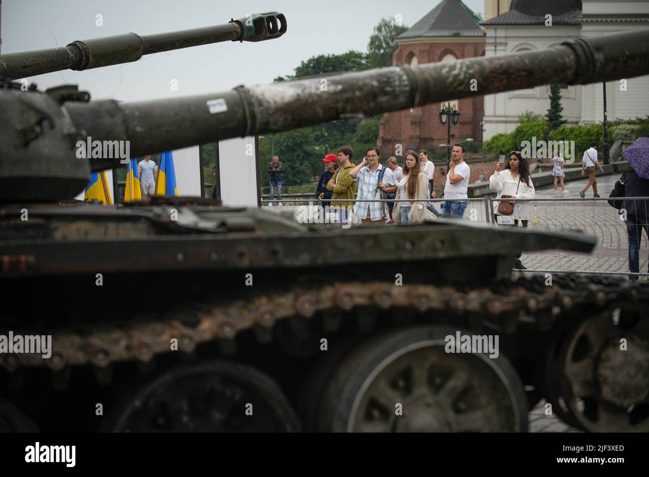 Visitors look at Russian tanks on display near the Royal Castle in ...
