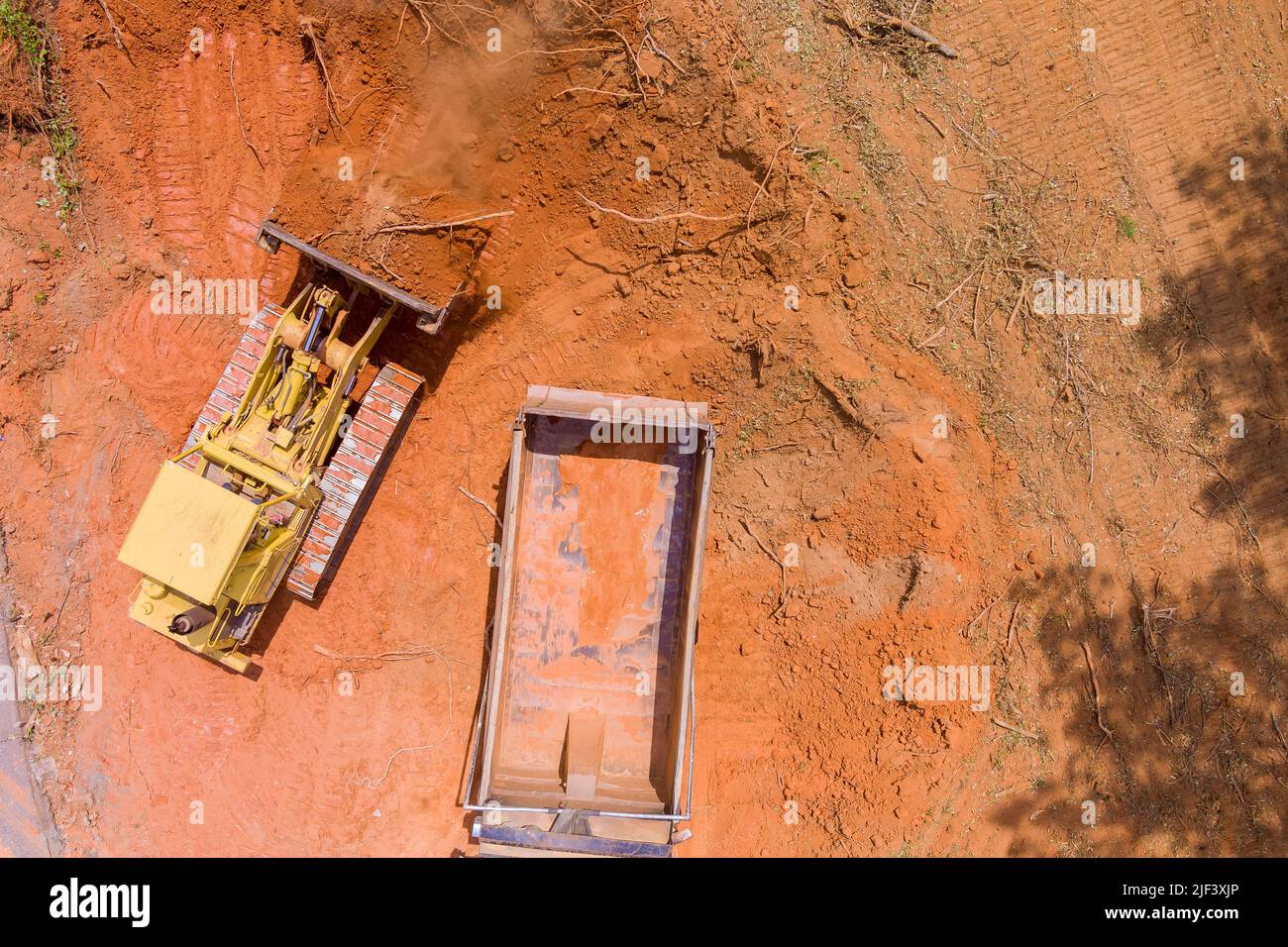 Aerial view of excavator loading land into dump trucks Stock Photo - Alamy