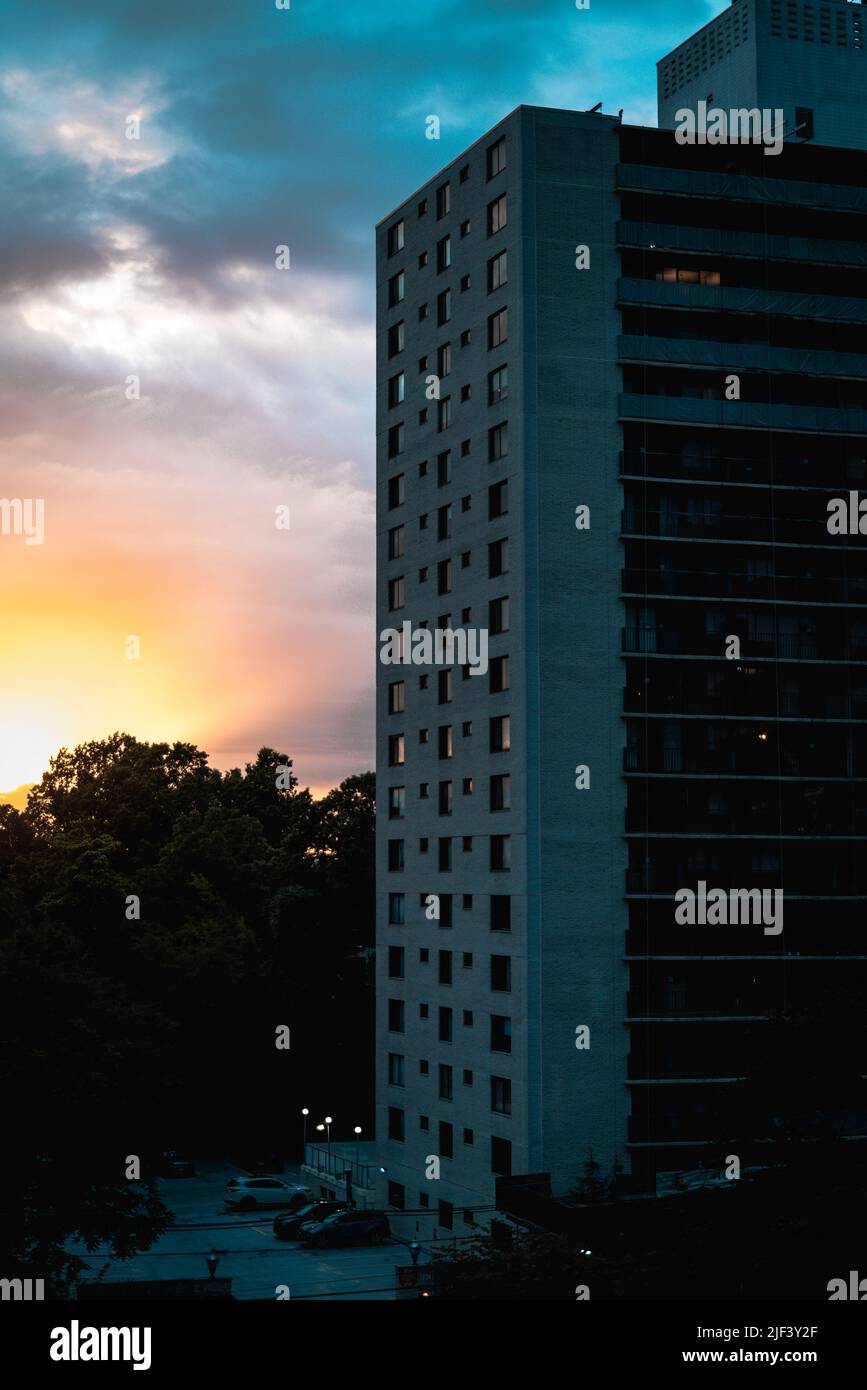 Dramatic sunbeams behind the Residential Building With Reflections in a ...