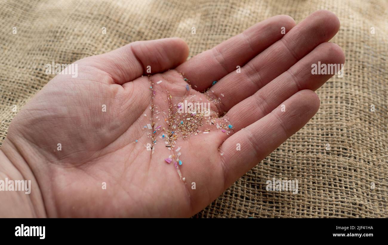Close-up on micro plastic particles in a person's hand. Concept for ...