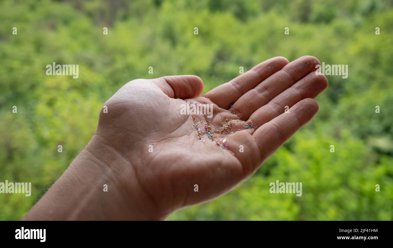 Close-up on micro plastic particles in a person's hand. Concept for ...