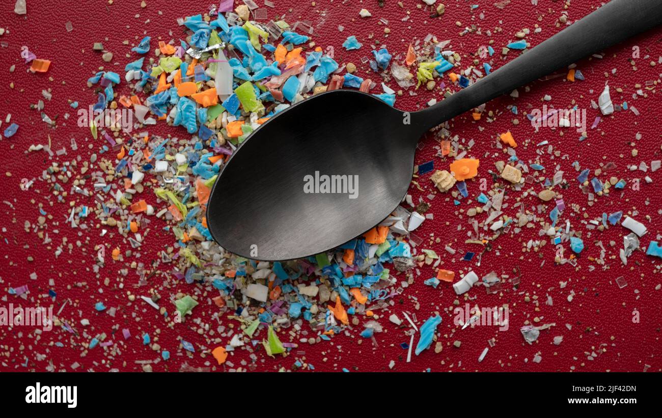 Close-up top shot of microplastic particles in a spoon. Concept for ...