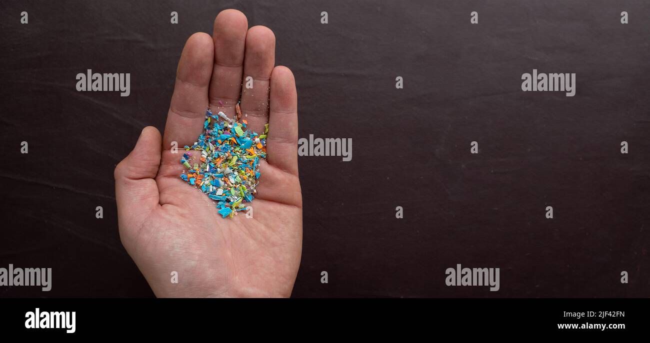 Close-up on micro plastic particles in a person's hand. Concept for ...