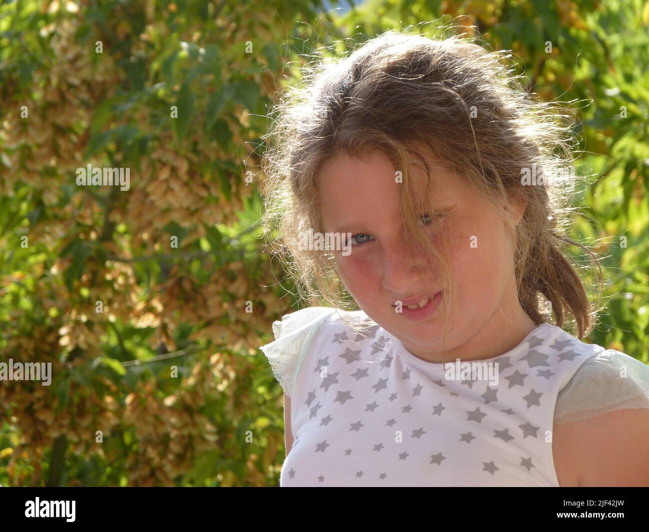 Child girl playing under the tree. Beautiful portrait of a child. Child ...