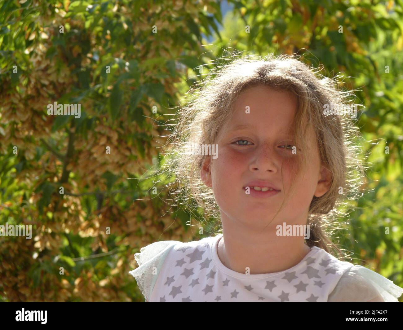 Child girl playing under the tree. Beautiful portrait of a child. Child ...