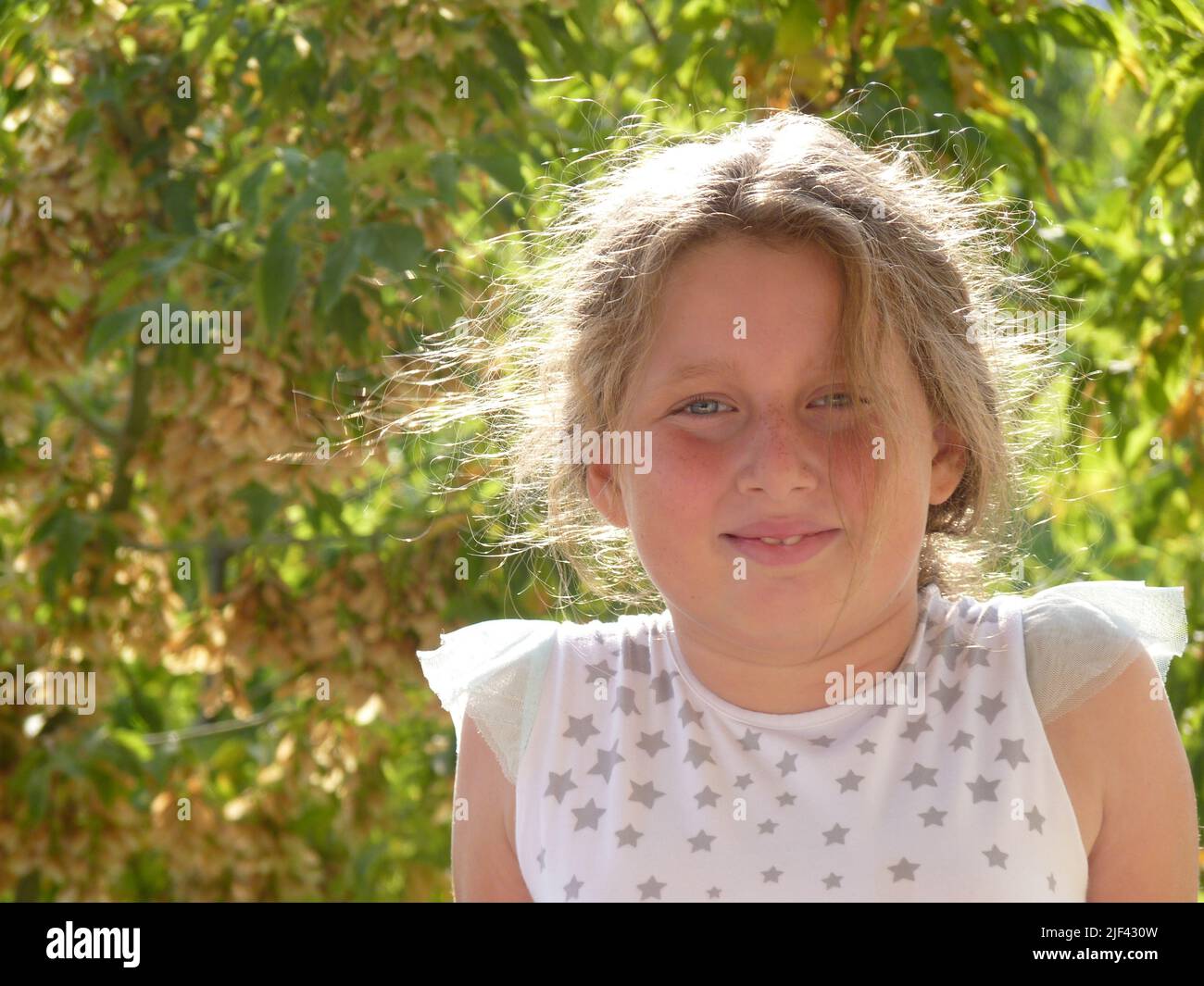 Child girl playing under the tree. Beautiful portrait of a child. Child ...