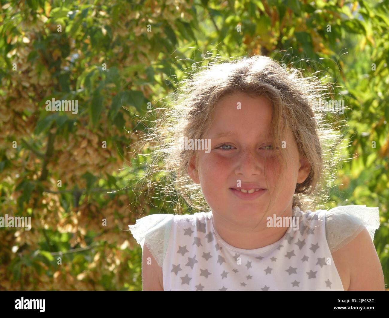 Child girl playing under the tree. Beautiful portrait of a child. Child ...
