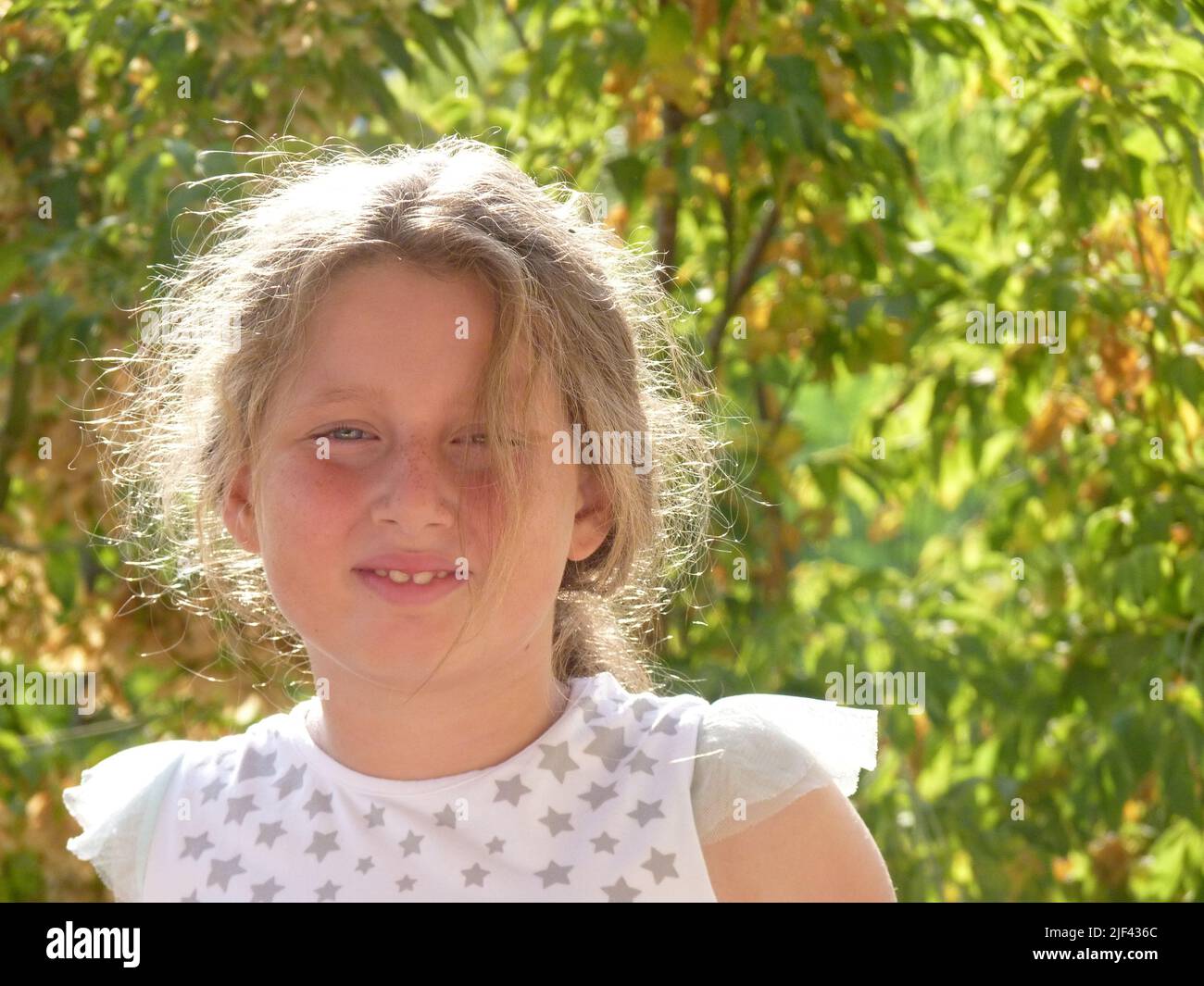 Child girl playing under the tree. Beautiful portrait of a child. Child ...