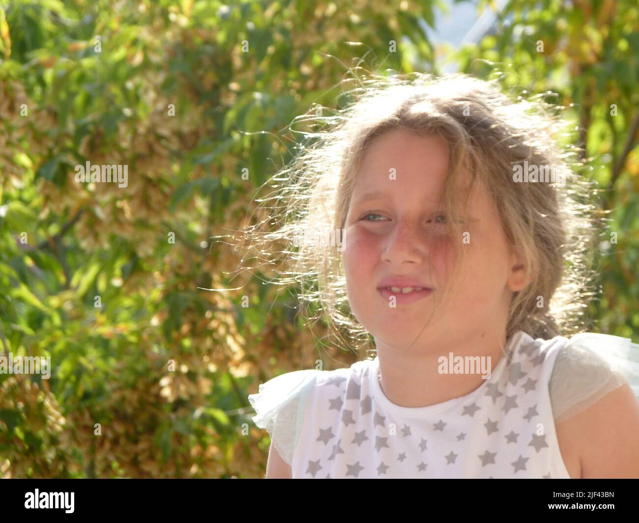 Child girl playing under the tree. Beautiful portrait of a child. Child ...