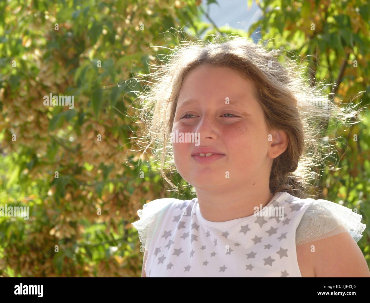 Child girl playing under the tree. Beautiful portrait of a child. Child ...