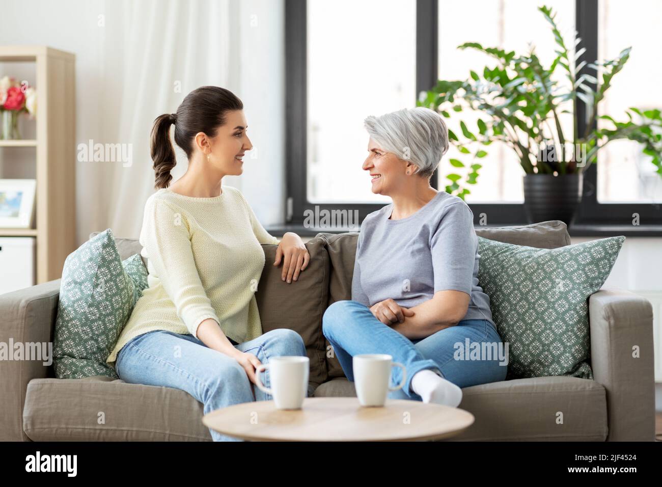 senior mother with adult daughter talking at home Stock Photo - Alamy